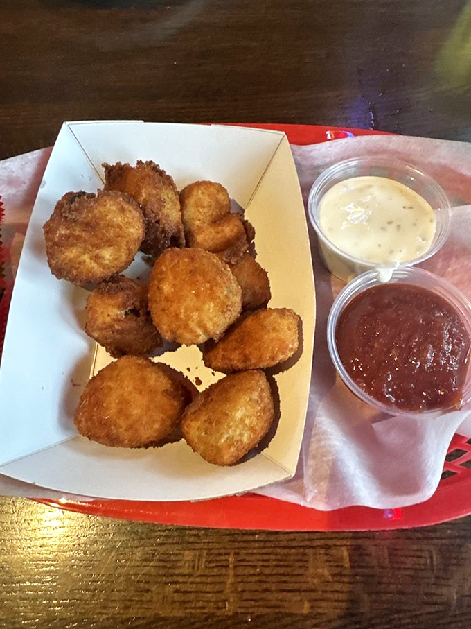 These golden-brown fried pickles aren't just appetizers; they're little discs of joy that make you wonder why anyone would eat a pickle any other way.