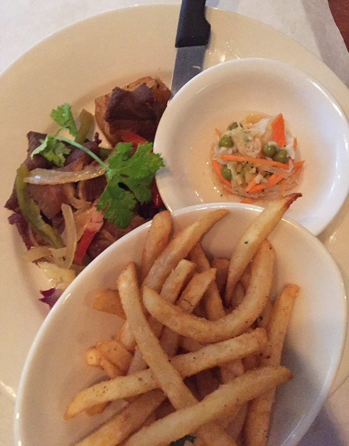 Three perfect companions: seasoned fries, fresh slaw, and meat that's been lovingly cooked. A plate that proves simple pleasures are often the most profound.