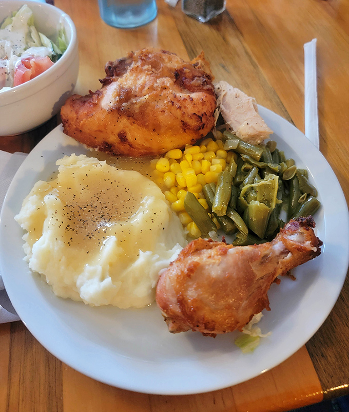Fried chicken so perfectly golden it deserves its own trophy, accompanied by the holy trinity of Midwestern sides&mdash;mashed potatoes, corn, and green beans.
