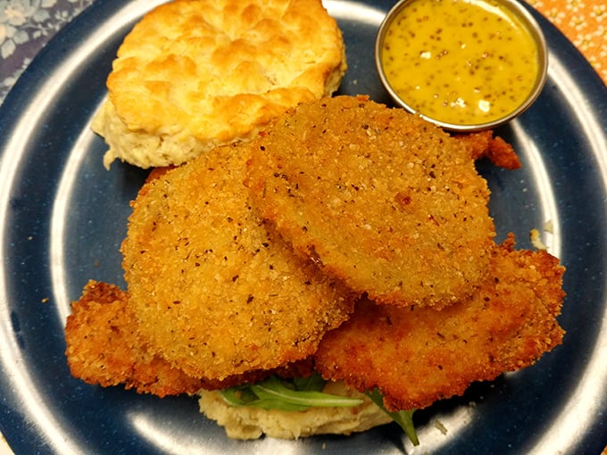 The holy grail: perfectly fried green tomatoes with that ideal cornmeal crunch, served alongside a biscuit that deserves its own fan club.