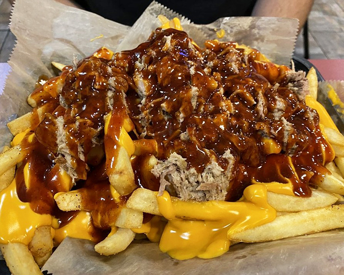 Cheese fries topped with pulled pork and sauce&mdash;because sometimes your arteries just need to live a little dangerously.
