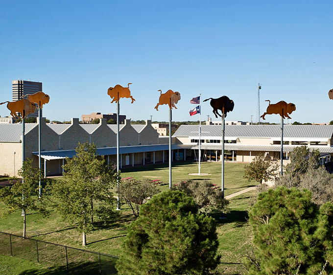 Frontier Texas! celebrates the state's rugged heritage with these whimsical buffalo silhouettes standing tall against the Texas sky like metallic sentinels of history.