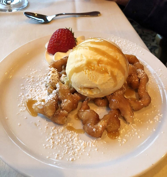 Funnel cake gets the grown-up treatment with caramelized apples and vanilla ice cream. Carnival food with a college education.