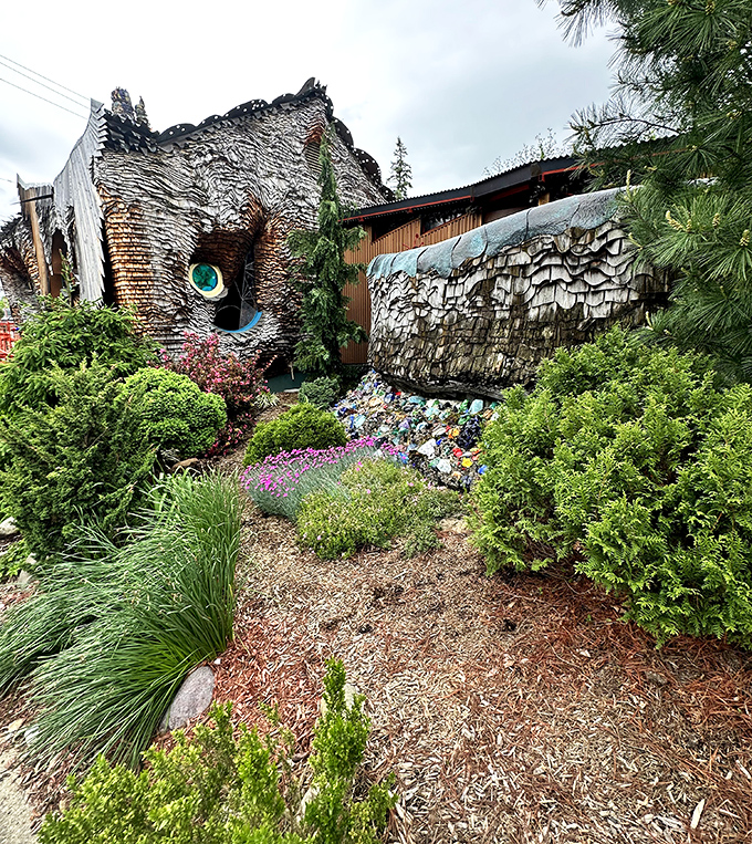 The landscaping complements the home's whimsical design, with carefully placed shrubs and colorful garden elements enhancing its storybook quality.