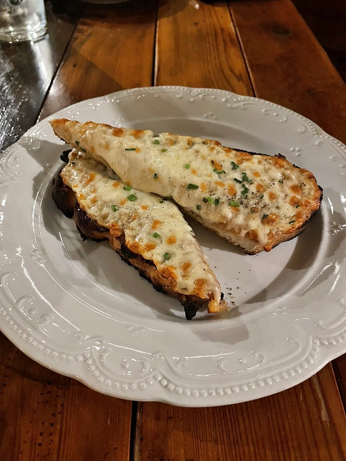 These golden-brown crostini, bubbling with melted cheese, are what garlic bread dreams of becoming when it grows up.