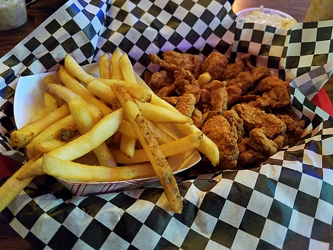 Fried fish so perfectly golden it practically glows, served in classic checkered paper&mdash;proof that simplicity, when done right, beats fancy plating every time.