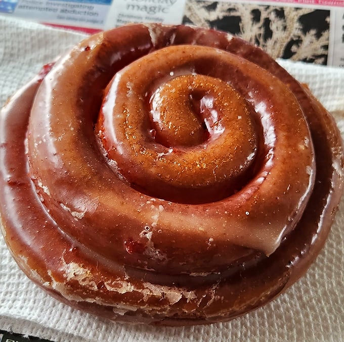 This cinnamon roll isn't just glazed&mdash;it's practically lacquered with sweetness, each spiral promising a journey deeper into flavor.
