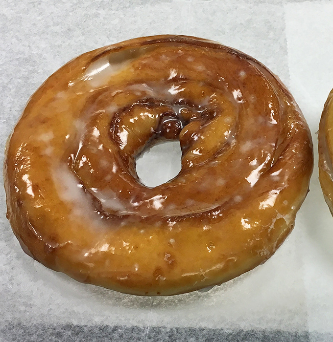 The platonic ideal of a glazed doughnut &ndash; that perfect amber sheen catching the light like a sugary stained glass window.