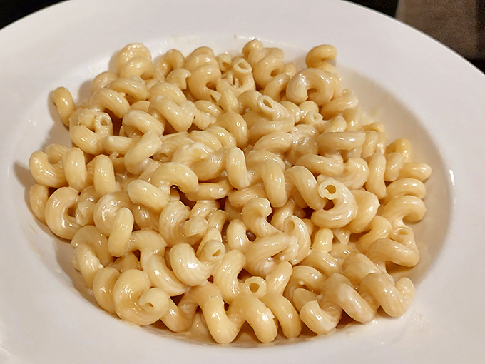 Mac and cheese so creamy it should require a permission slip. This isn't just comfort food; it's a warm hug for your taste buds.