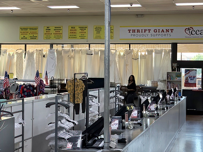 Wedding gowns and formal wear create a wall of white elegance. Someone's once-in-a-lifetime dress becomes another's affordable dream. 