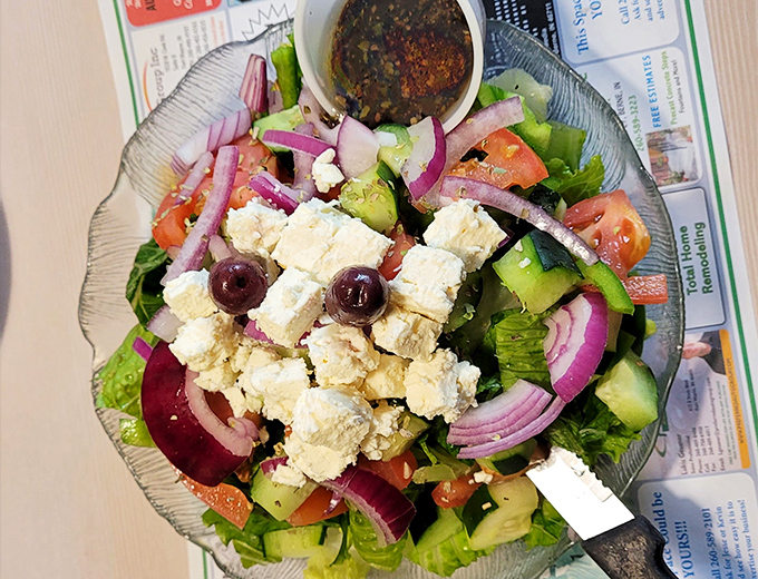 A Greek salad that actually traveled to Greece once and came back with stories to tell. Those feta chunks are practically monuments.