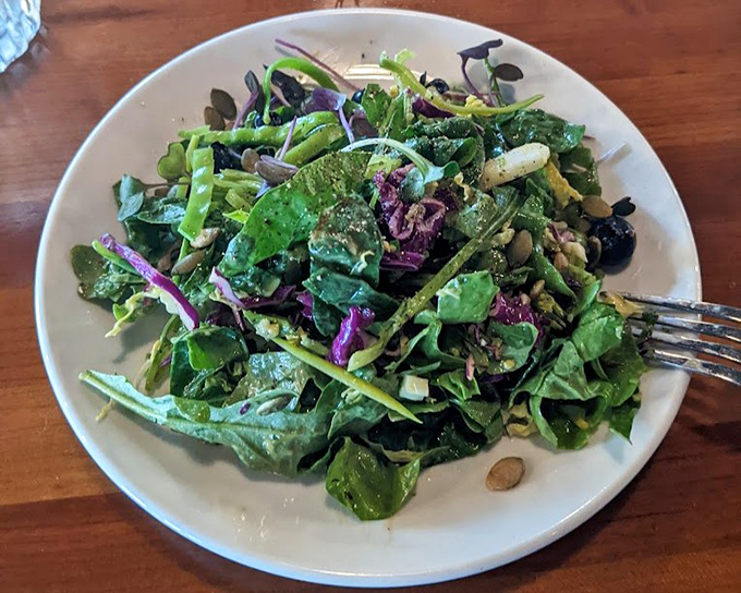 A salad so vibrant and fresh it might make you forget you came for pizza—almost. Those greens look like they were harvested minutes ago.