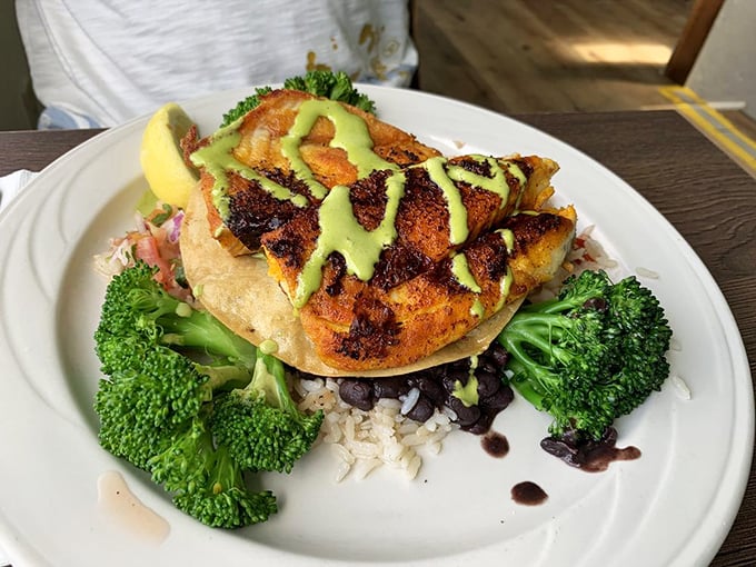 Blackened barramundi that's having its glamour shot moment. That vibrant green sauce isn't just pretty&mdash;it's the perfect tangy counterpoint.