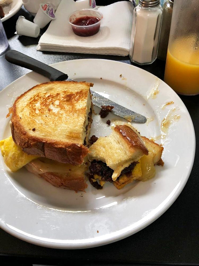Half-eaten grilled cheese tells the whole story: crispy, gooey, and disappearing too quickly to capture intact. The struggle is real.