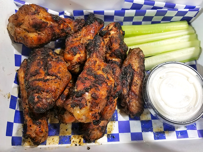 These wings aren't just grilled; they're having a spiritual experience over open flame. The celery is just there to witness the glory.