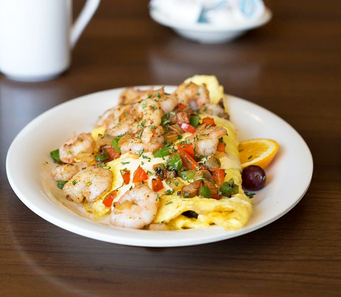 The Grilled Shrimp Omelet proves breakfast and seafood belong together like beach days and sunscreen. Florida breakfast perfection on a plate.