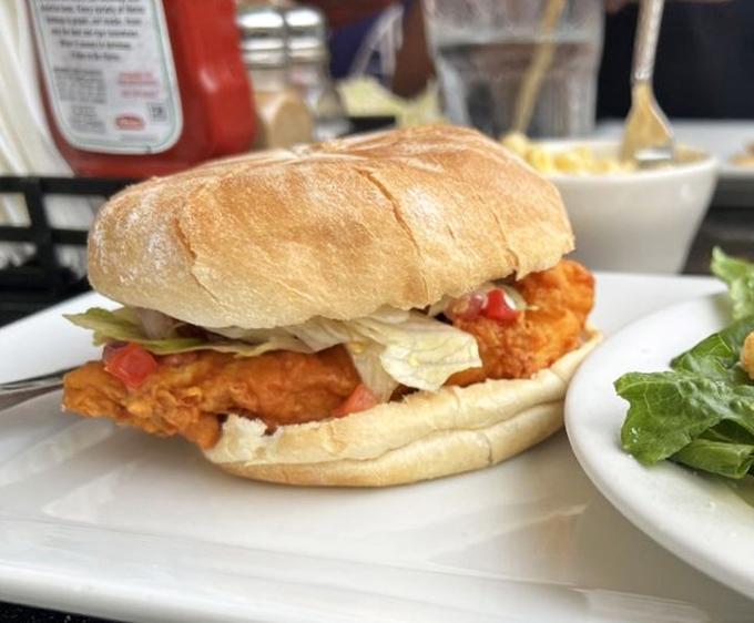 Sandwich architecture at its finest. This fried grouper creation proves that sometimes the best things in life come between two pieces of bread.