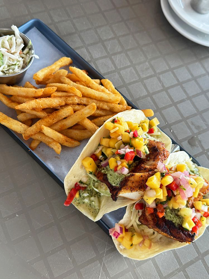 Grouper tacos that make you question every life decision that didn't involve eating these sooner. The mango salsa seals the deal.