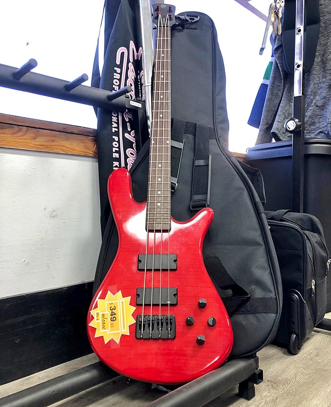 That cherry-red bass guitar isn't just an instrument; it's someone's abandoned rock star dreams waiting for your fingers to revive them.