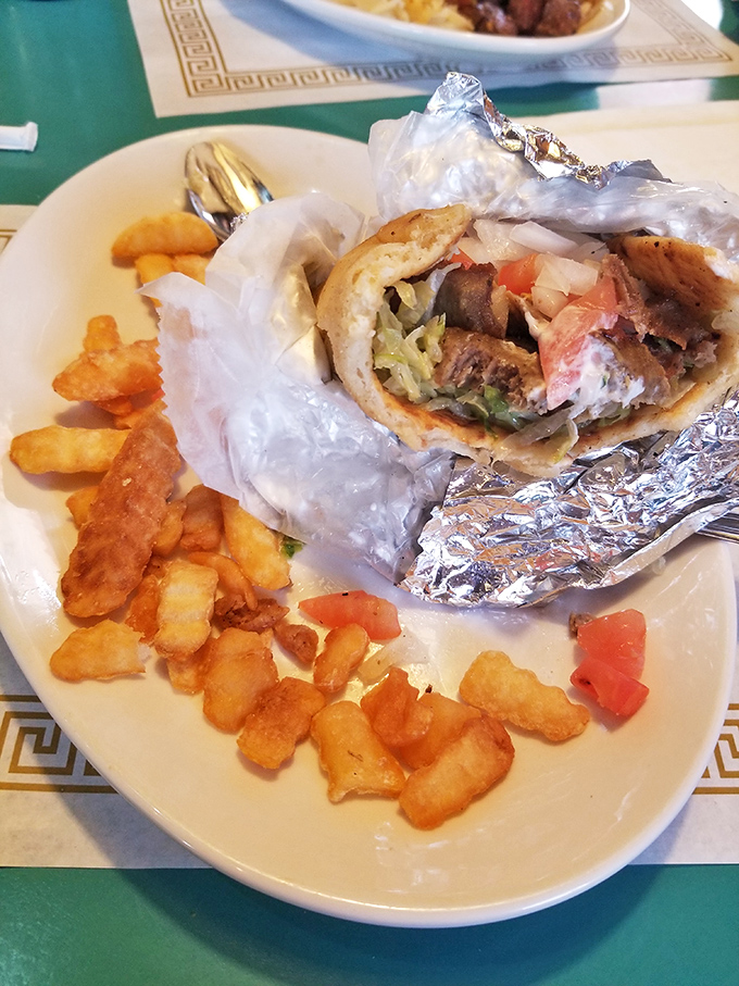 This gyro wrapped in foil isn't trying to win beauty contests&mdash;it's too busy delivering Mediterranean flavors alongside perfectly crispy home fries.