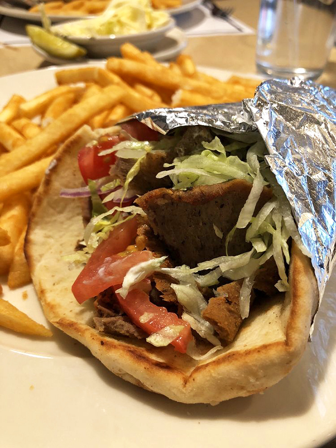 This isn't just a gyro&mdash;it's an edible architecture project where crispy, savory meat meets garden-fresh veggies in a warm pita embrace.