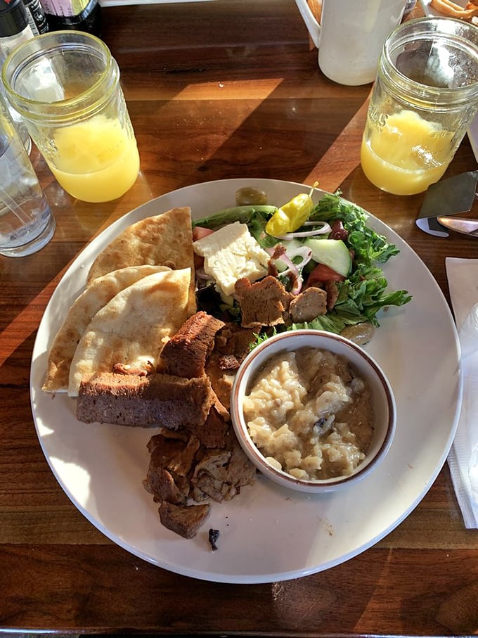 Sunlight dancing on a perfectly plated gyro platter. The pita looks so fresh it might have been baked while you were parking.