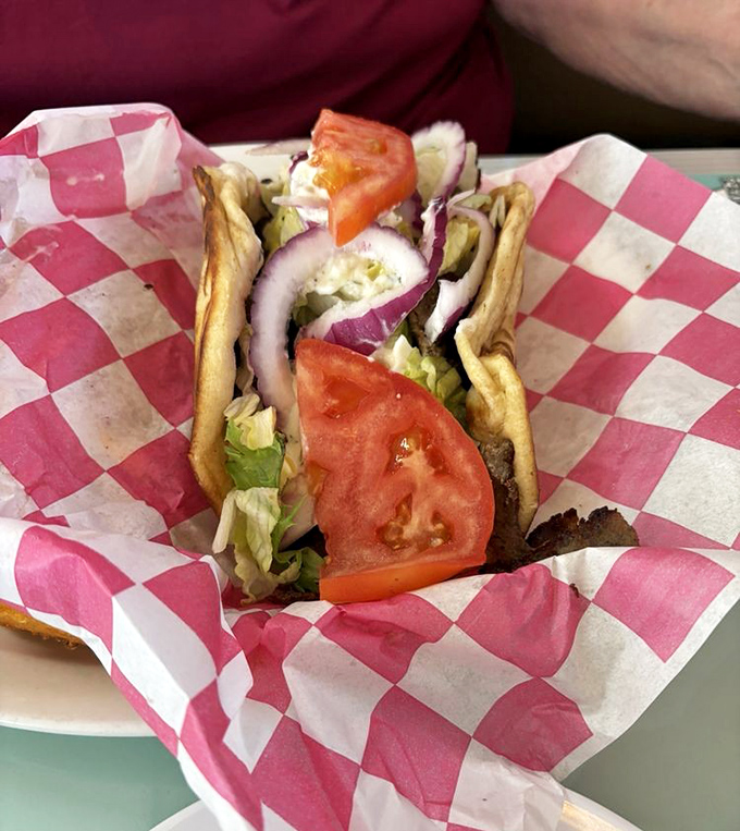 A proper gyro – where the pita is merely a delivery system for a garden of fresh veggies and seasoned meat. Napkins required.