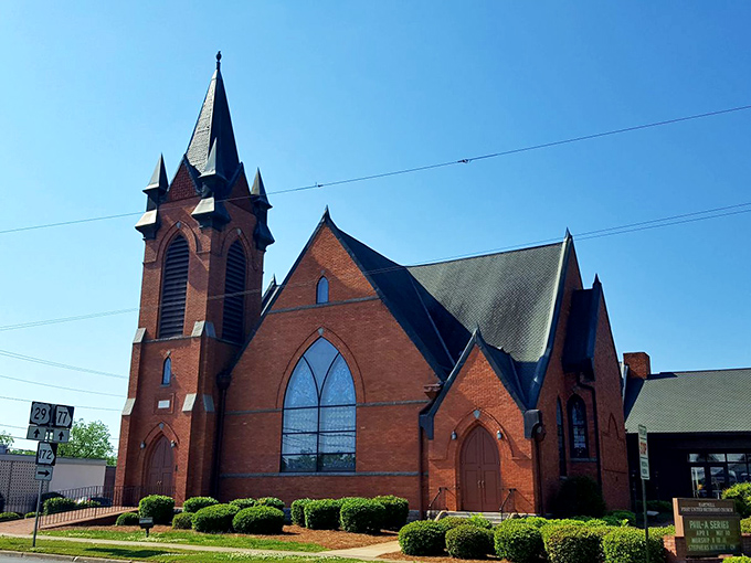The red brick Methodist church reaches skyward with a steeple that's been the town's spiritual compass since horse-drawn buggies clip-clopped past its doors.