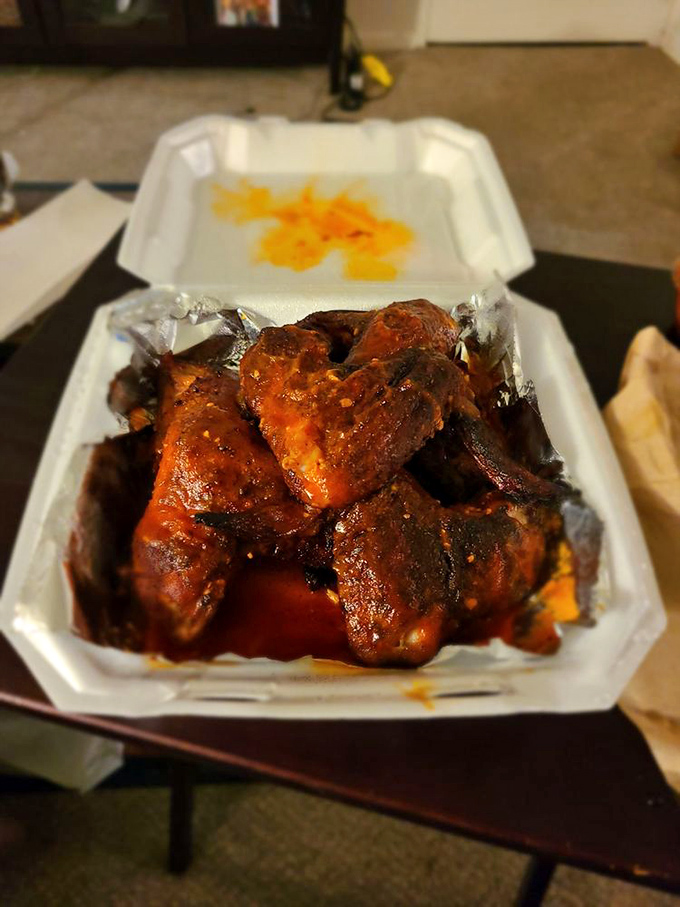 Hot wings that look like they've been gossiping with hickory smoke all day. That deep mahogany color isn't makeup—it's earned through hours of patient smoking.