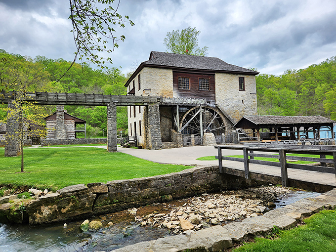 The iconic limestone mill stands as a testament to pioneer ingenuity, its massive wheel ready to harness the power of rushing water.