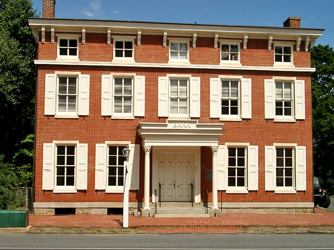 The Historic Odessa Bank building stands as a testament to early American financial ambition. Those white shutters pop against the brick like exclamation points in a history book.
