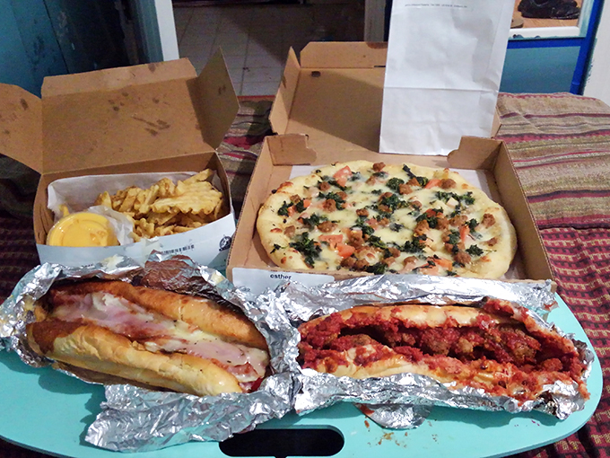 A feast fit for sharing (or not) &ndash; hoagies, pizza, and fries creating the kind of spread that turns strangers into friends.