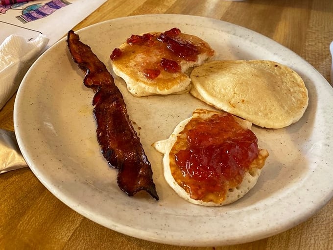 Pancakes with jam, bacon on the side—simple pleasures that remind us why breakfast will always be the champion of meals.