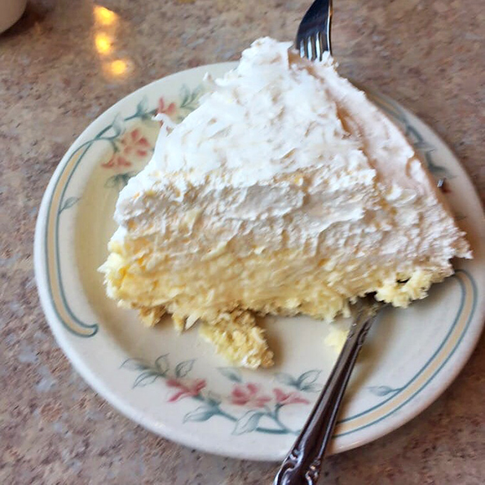 A slice of homemade cream pie so light and fluffy it might float away if not anchored by your eager fork.