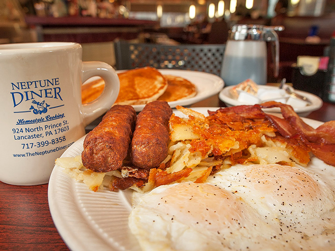 Breakfast perfection on a plate: crispy home fries, perfectly cooked eggs, and sausage links that snap with each bite. The coffee mug stands guard.