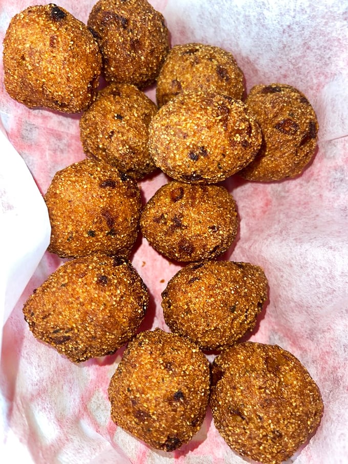 Hush puppies so golden and perfect they deserve their own Instagram account. Crispy exterior, tender cornmeal interior &ndash; seafood's perfect sidekick.