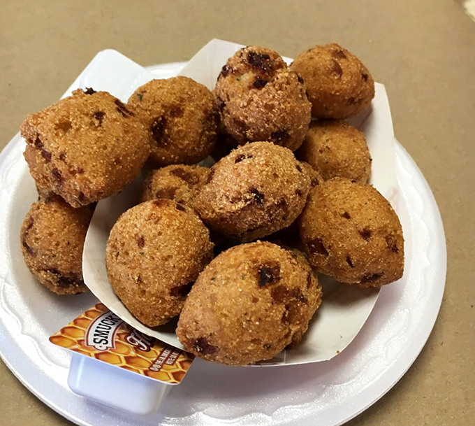 Hush puppies: golden-fried cornmeal spheres of joy that somehow make waiting for your crab feast feel like a reward, not a punishment.