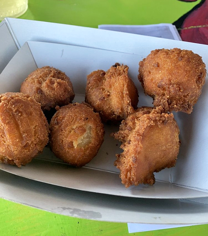 Hush puppies that would make your Southern grandmother weep with joy. Golden-brown orbs of cornmeal perfection waiting to be devoured between bites of seafood.