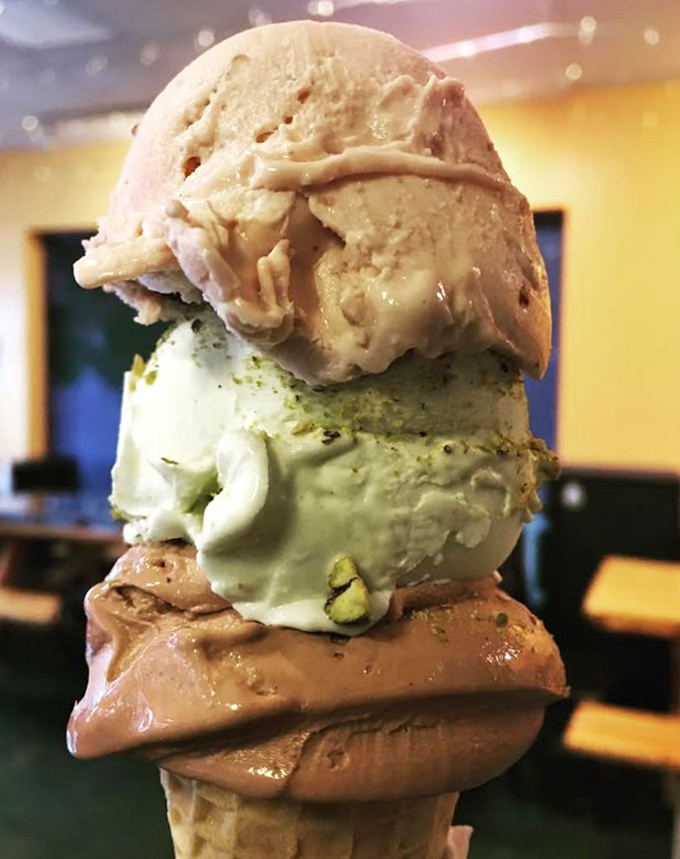 Ice cream towers that defy both gravity and sadness. Three distinct flavors stacked like a delicious Jenga game you're allowed to eat.