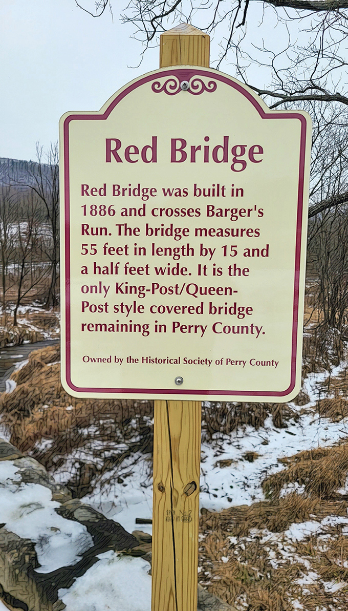 Winter's stark landscape frames this informational sign, revealing the bridge's King-Post/Queen-Post design—architectural royalty in Perry County.