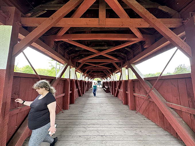 Walking through history has never been so literal. The worn planks beneath your feet have carried generations of travelers across this picturesque creek.