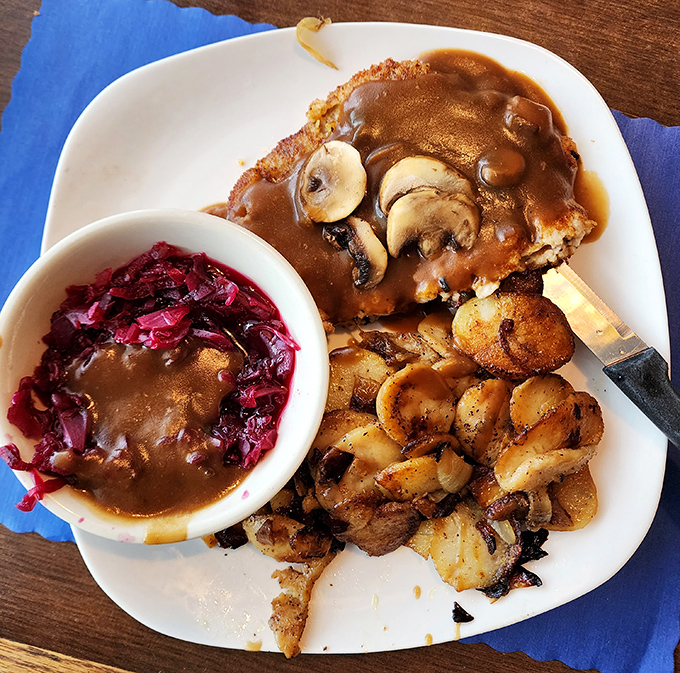 The Jager Schnitzel arrives like an ambassador from Bavaria&mdash;breaded cutlet draped in mushroom gravy with red cabbage providing that perfect tangy counterpoint.