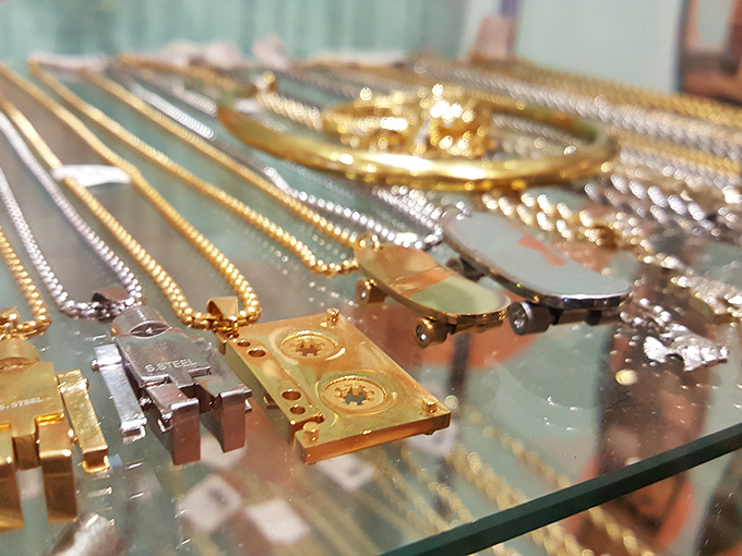 Gold cassette tape necklaces and chunky chains that would make Mr. T proud—jewelry that doesn't whisper vintage, it shouts it with boom box volume.