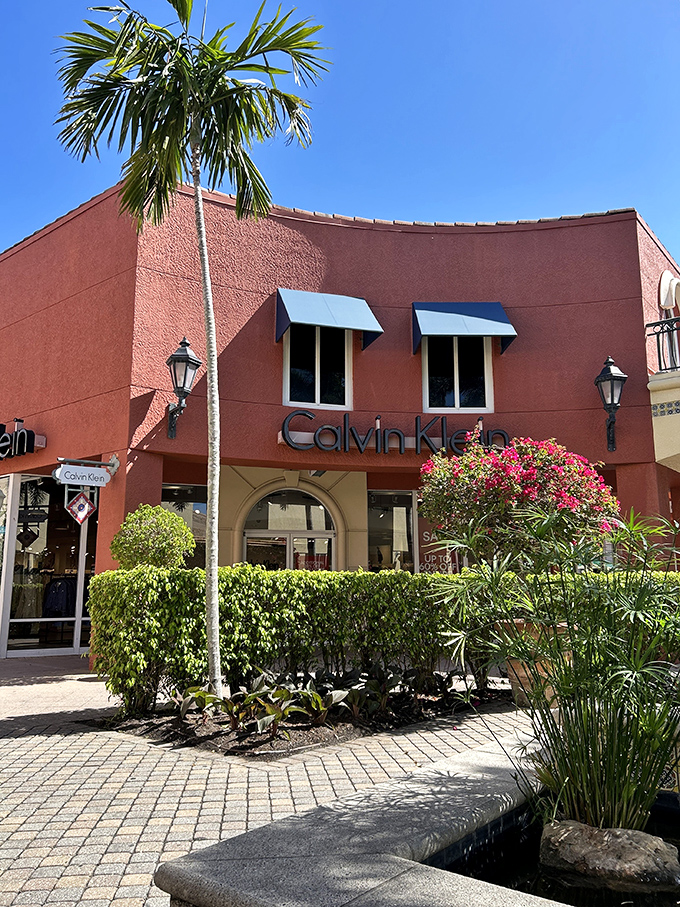 Calvin Klein's coral-hued storefront brings a pop of Miami flair to the outlets, surrounded by tropical landscaping that reminds you you're shopping in paradise.