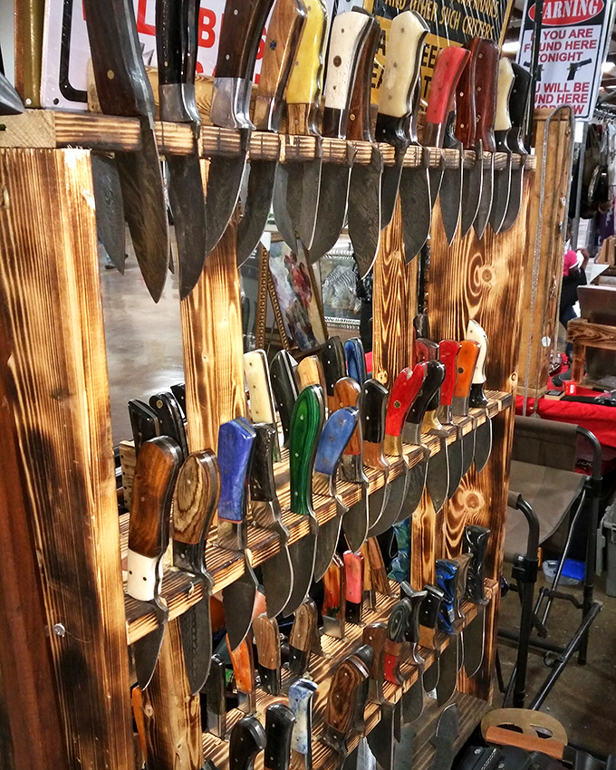 Knife nirvana for culinary enthusiasts and collectors alike. The wooden display showcases handles as colorful as a Mississippi sunset.