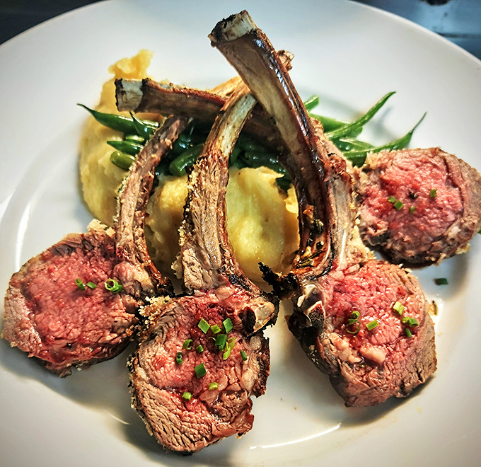 Rack of lamb presented like the crown jewels of dinner. That rosy center is what chefs dream about when they close their eyes.