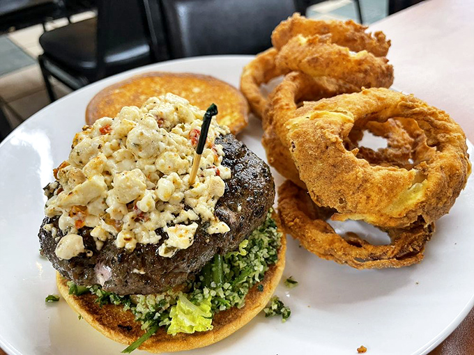 Not just any burger&mdash;this masterpiece topped with blue cheese crumbles and served with golden onion rings might just ruin all other burgers for you.