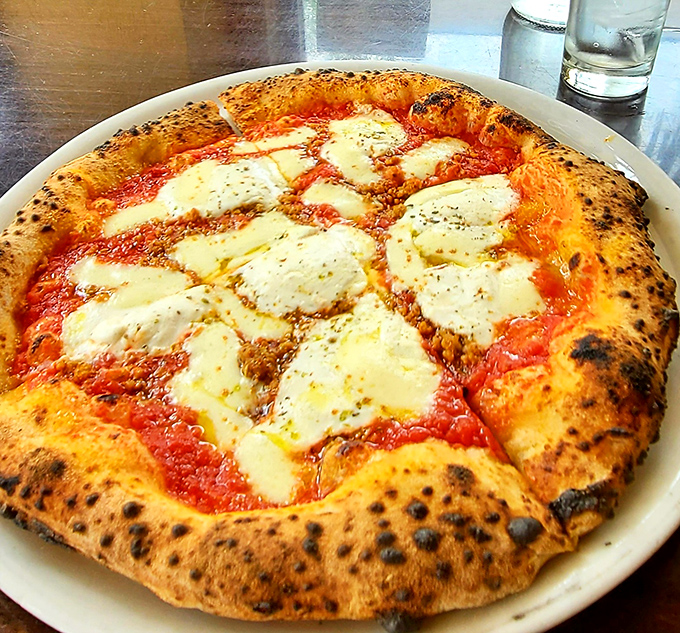 The Margherita pizza in its natural habitat&mdash;a simple circle of perfection that proves fewer ingredients, when they're the right ones, create magic.