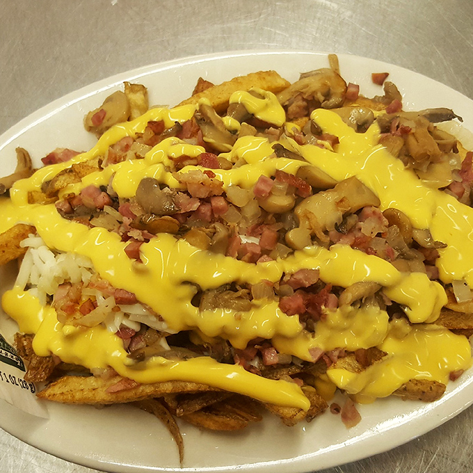 Loaded fries that make sharing impossible. That cheese sauce cascades like a yellow waterfall of happiness over potatoes, ham, and mushrooms.