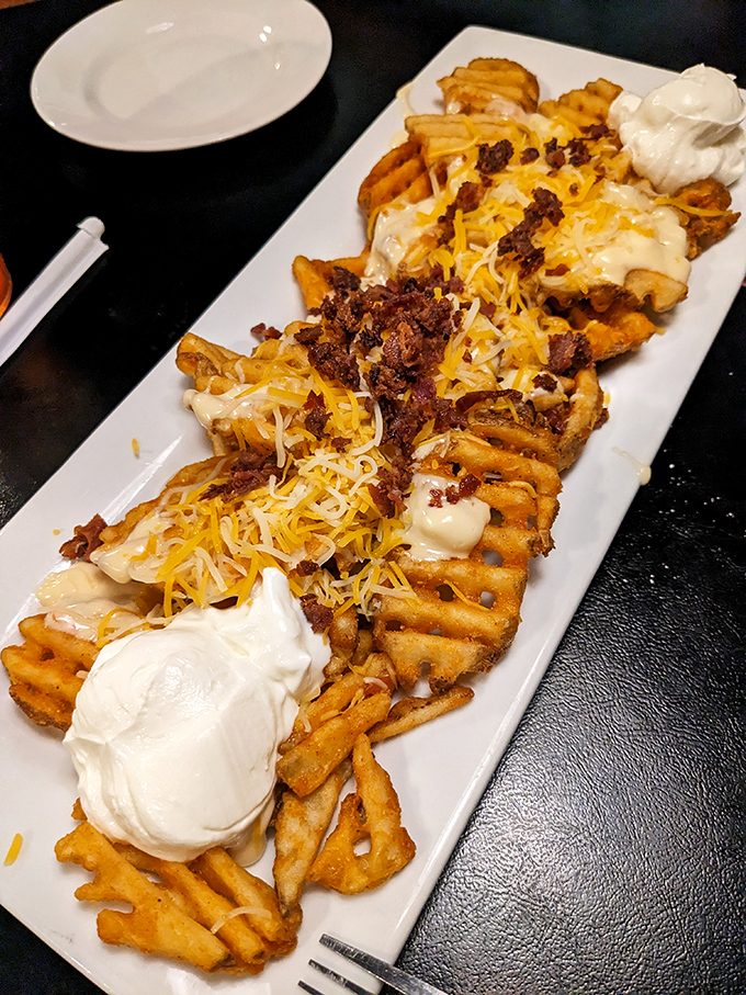 These loaded waffle fries aren't just a side dish&mdash;they're an engineering marvel of potato, cheese, bacon, and sour cream that demands your full attention.